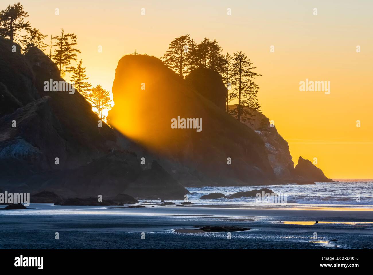 Sunset glowing on suspended sea spray and sea stacks at Point of Arches ...