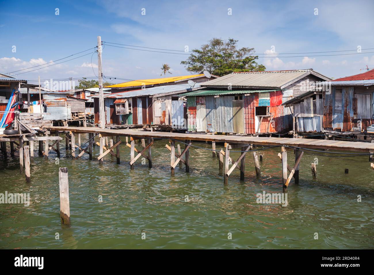 Wooden rickety houses and footbridges on stilts, coastal view of poor ...