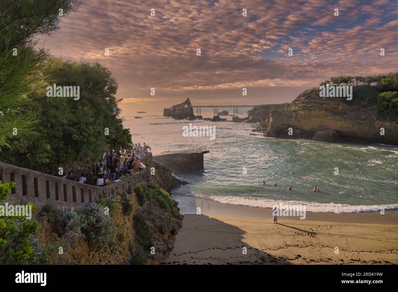 Biarritz, France, July, 2023 As the sun goes down revellers meet at the ...