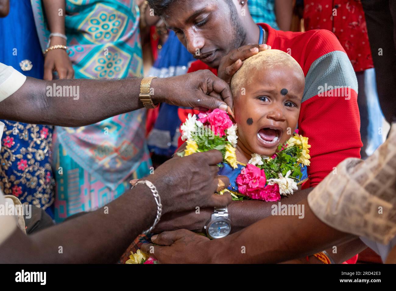 Young child screams as her ears are pierced in ceremony at Sri ...