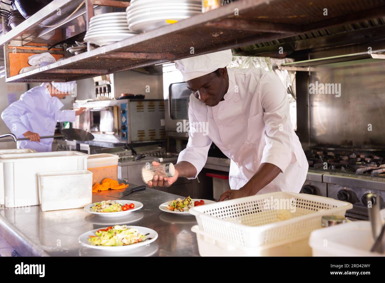 portrait of smiling male chef cooking in modern kitchen Stock Photo - Alamy