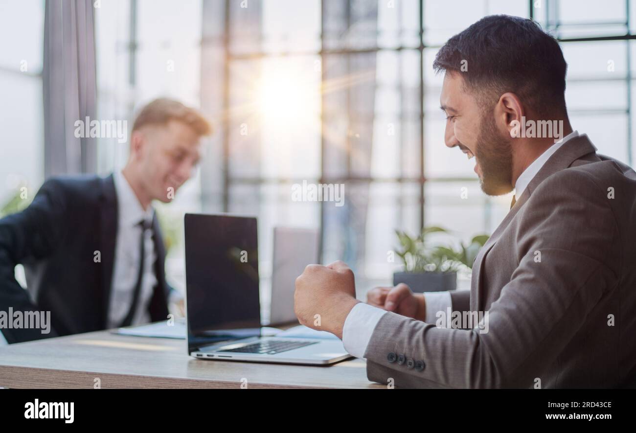 Two happy men working together on a new business project Stock Photo ...