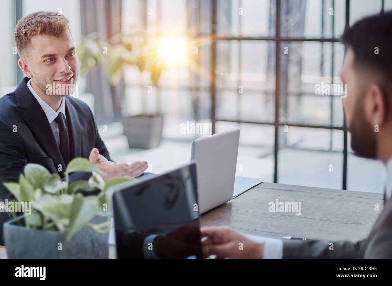 Two happy men working together on a new business project Stock Photo ...
