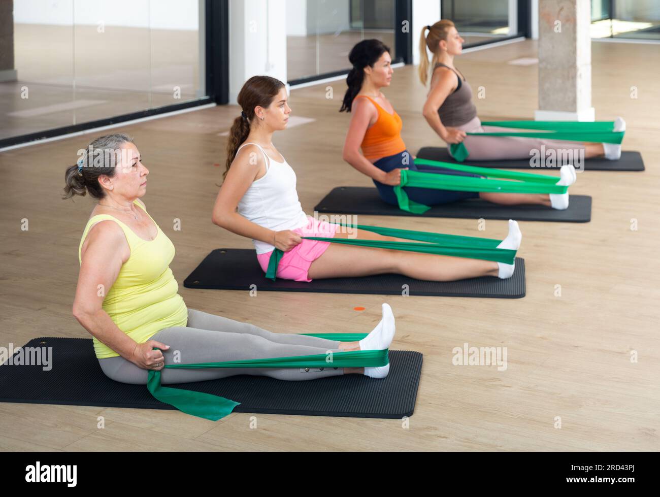 Women doing stretches with resistance bands Stock Photo - Alamy
