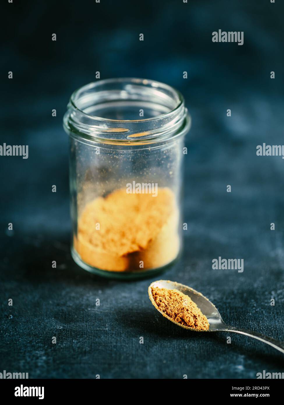 Indian or pakistani masala powder in spoon and glass jar. Homemade dry ...