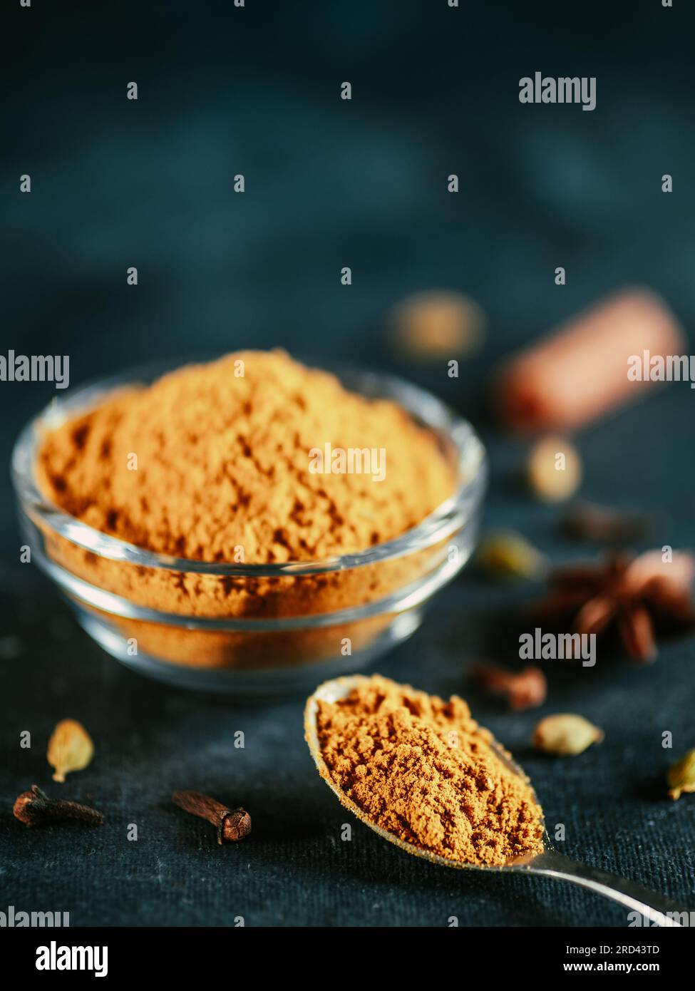 Indian or pakistani masala powder in spoon and glass jar. Homemade dry ...