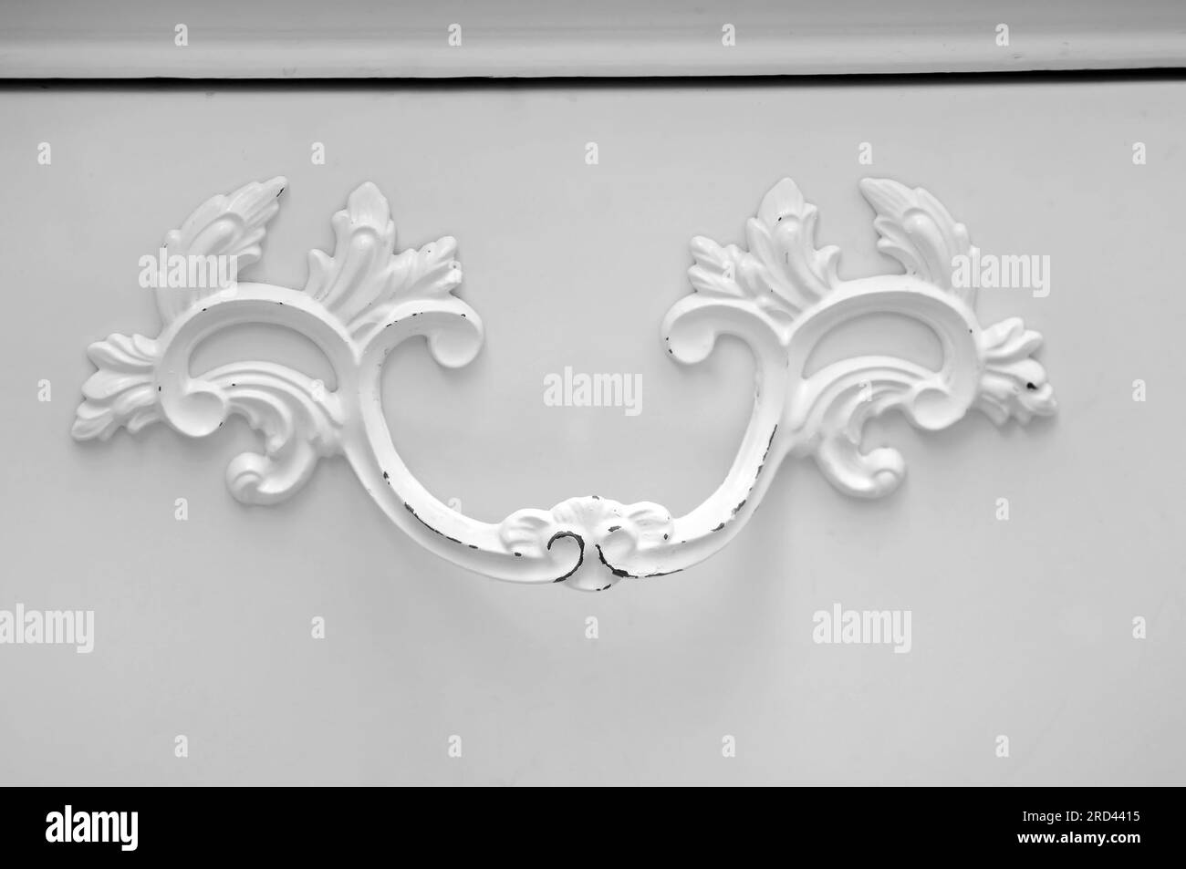 Image shows closeup of ornate and vintage metal drawer handle. Handle ...