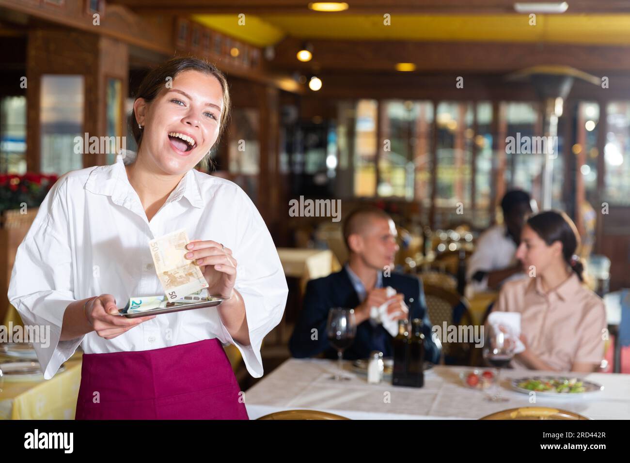 Happy waitress holding bill hi-res stock photography and images - Alamy