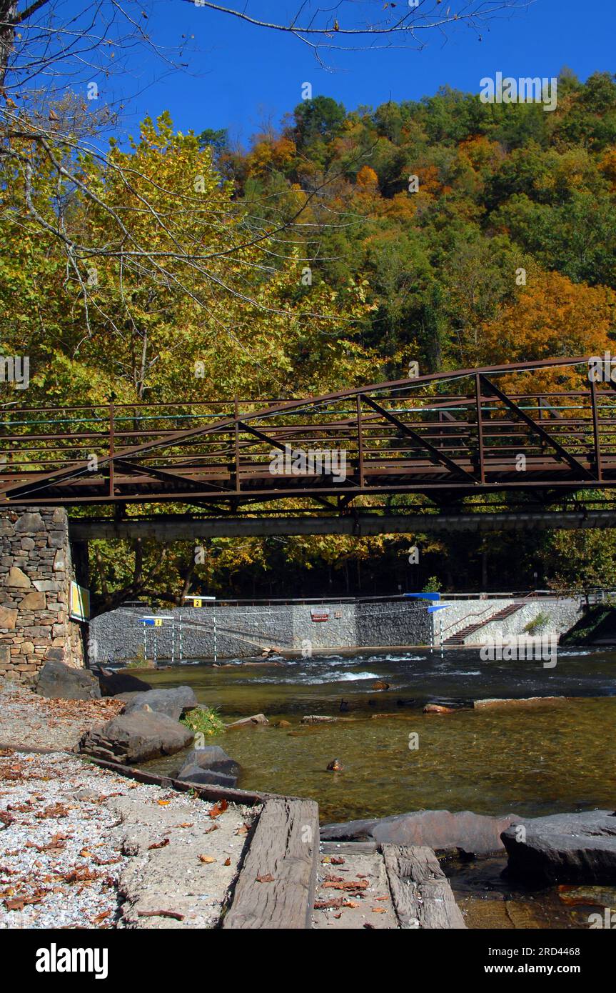 Kayak obstacle course is surrounded by Autumn color. Bridge spans river ...