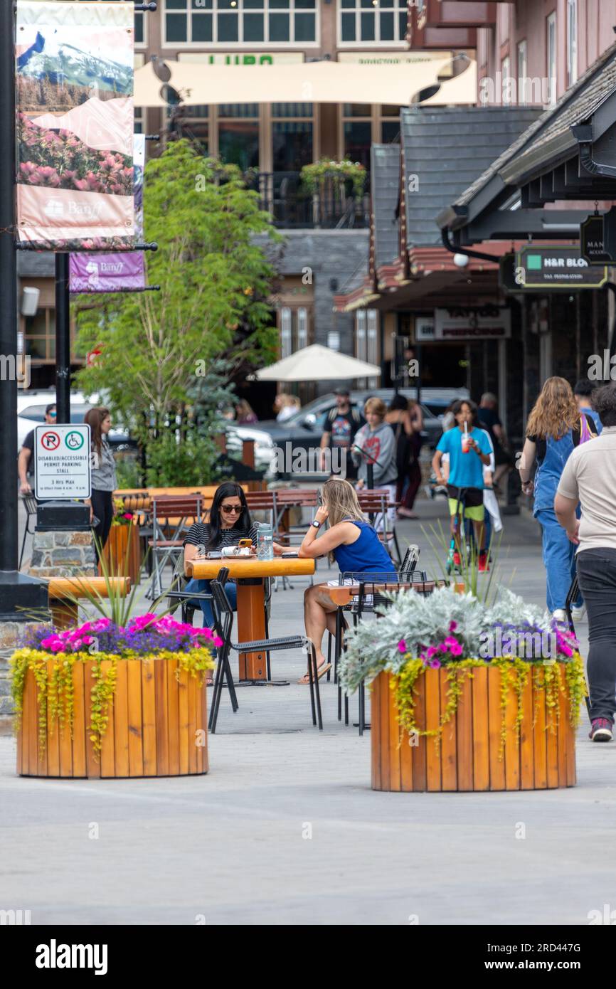 BANFF, CANADA - JULY 5, 2023: Tourists enjoying Banff townsite in the ...