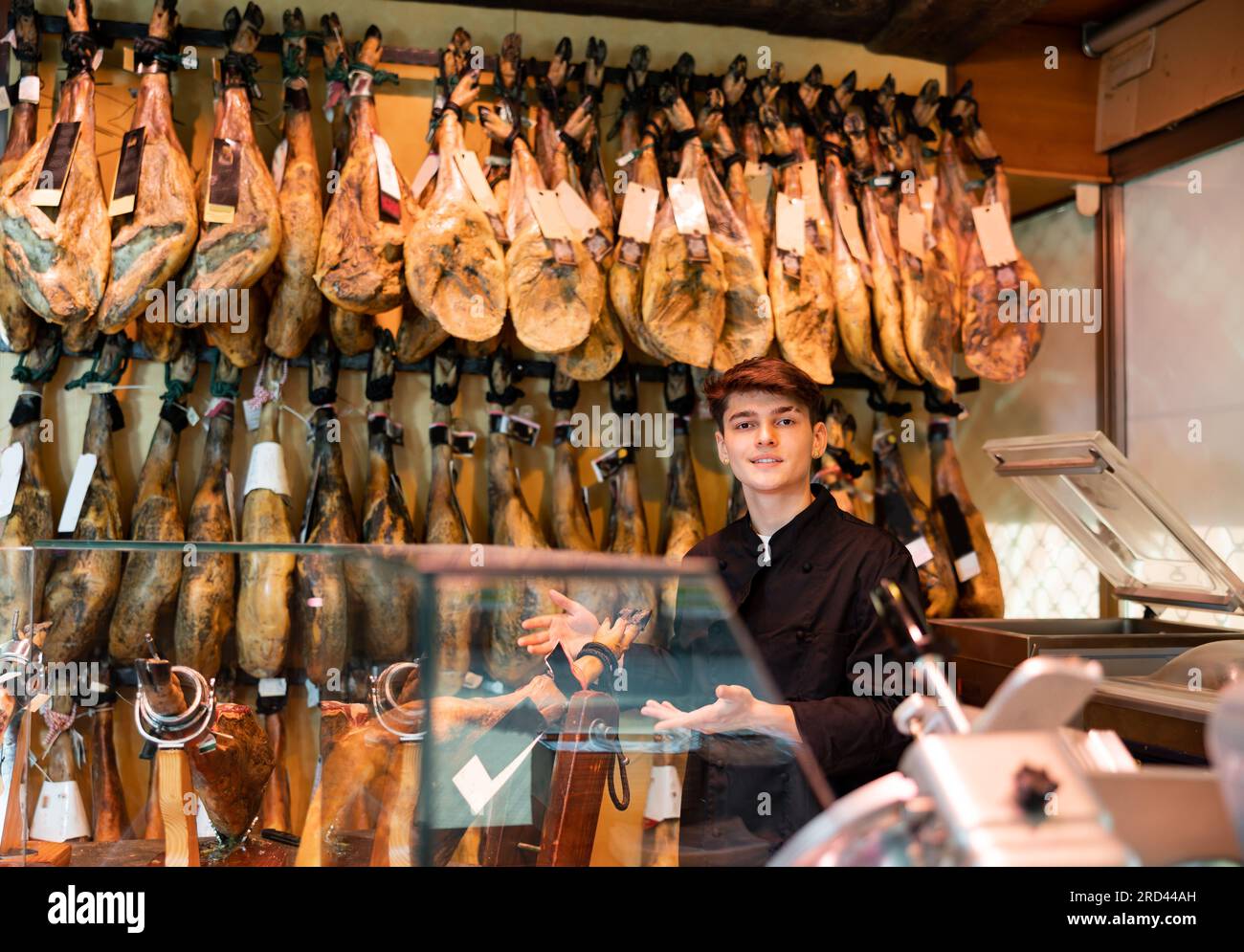 Owner of butcher shop selling traditional spanish jamon Stock Photo - Alamy