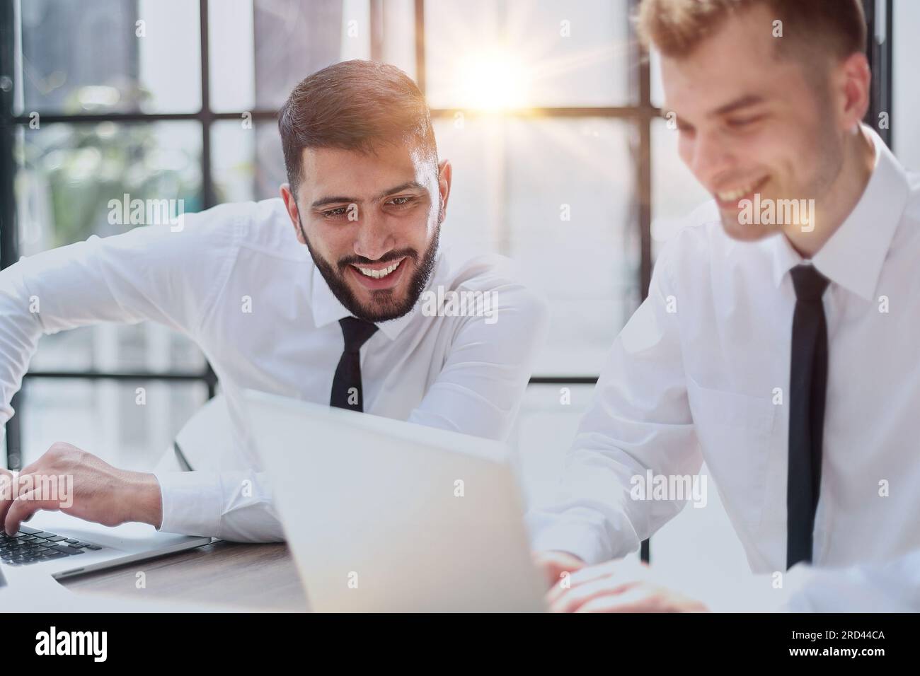 Two happy men working together on a new business project Stock Photo ...