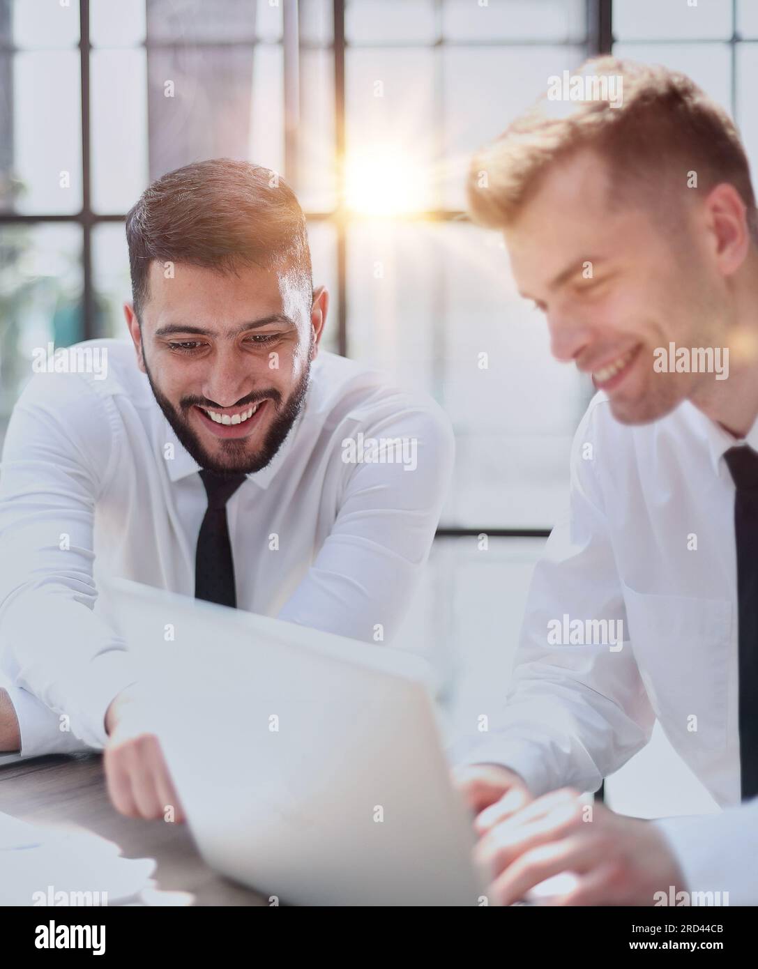 Two happy men working together on a new business project Stock Photo ...