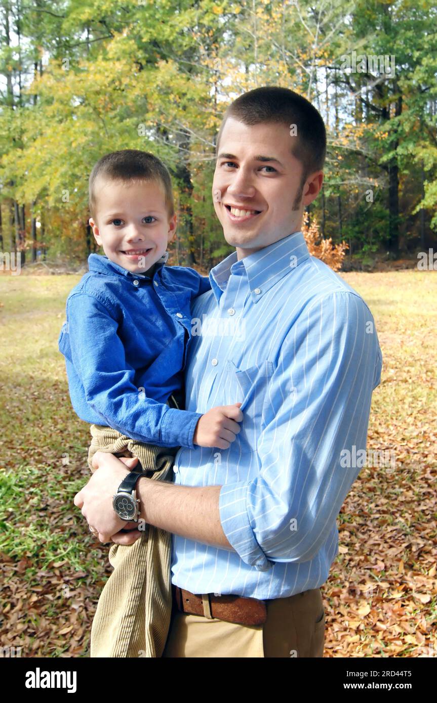 Father And Son Enjoy A Day Outside On An Autumn Afternoon Dad Is