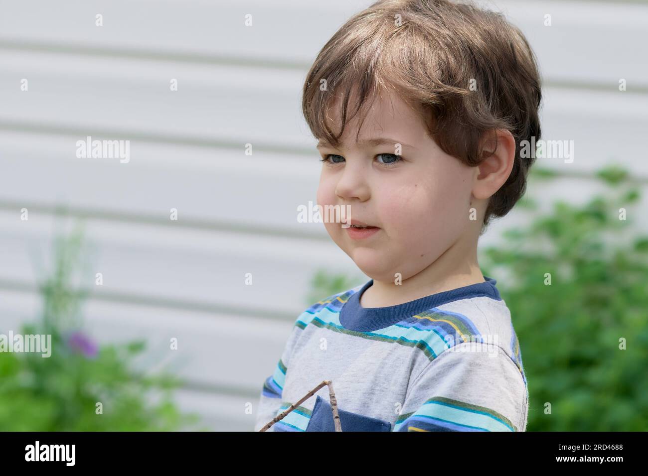 Cute baby boy playing with a stick in the backyard Stock Photo - Alamy