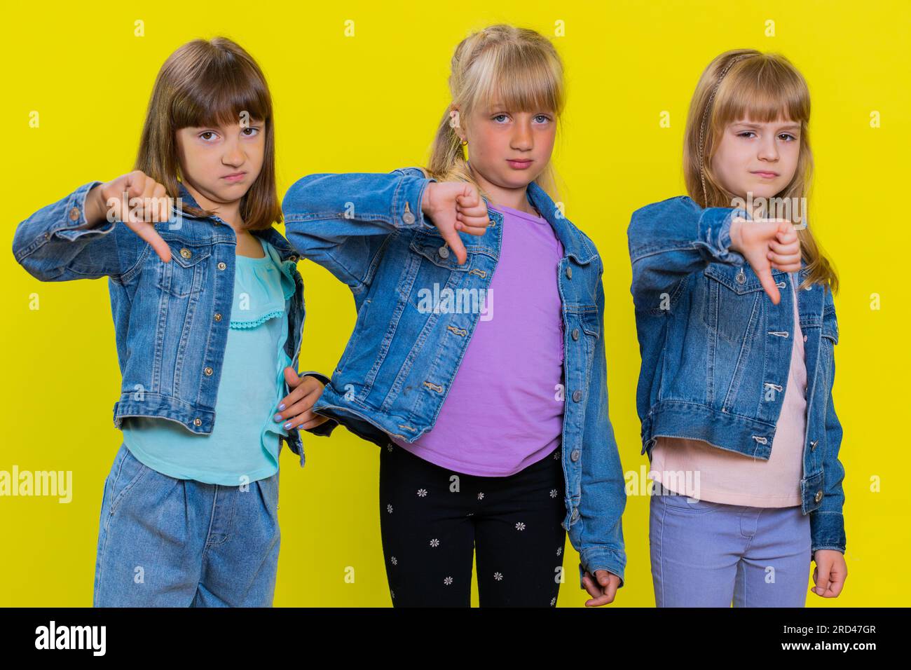 Dislike. Upset teenage girls showing thumbs down sign gesture ...