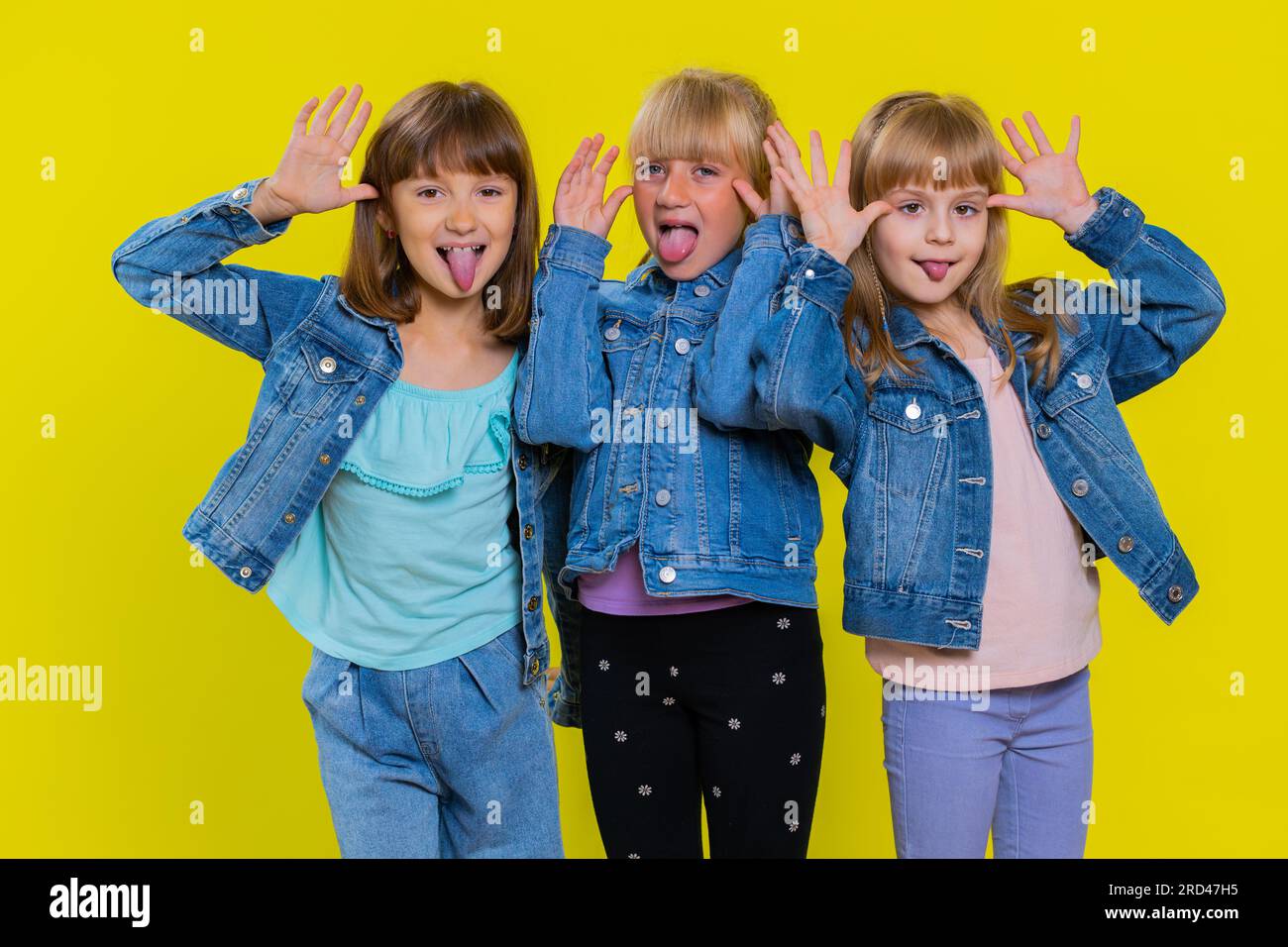 Funny happy teenage girls making playful silly facial expressions and ...