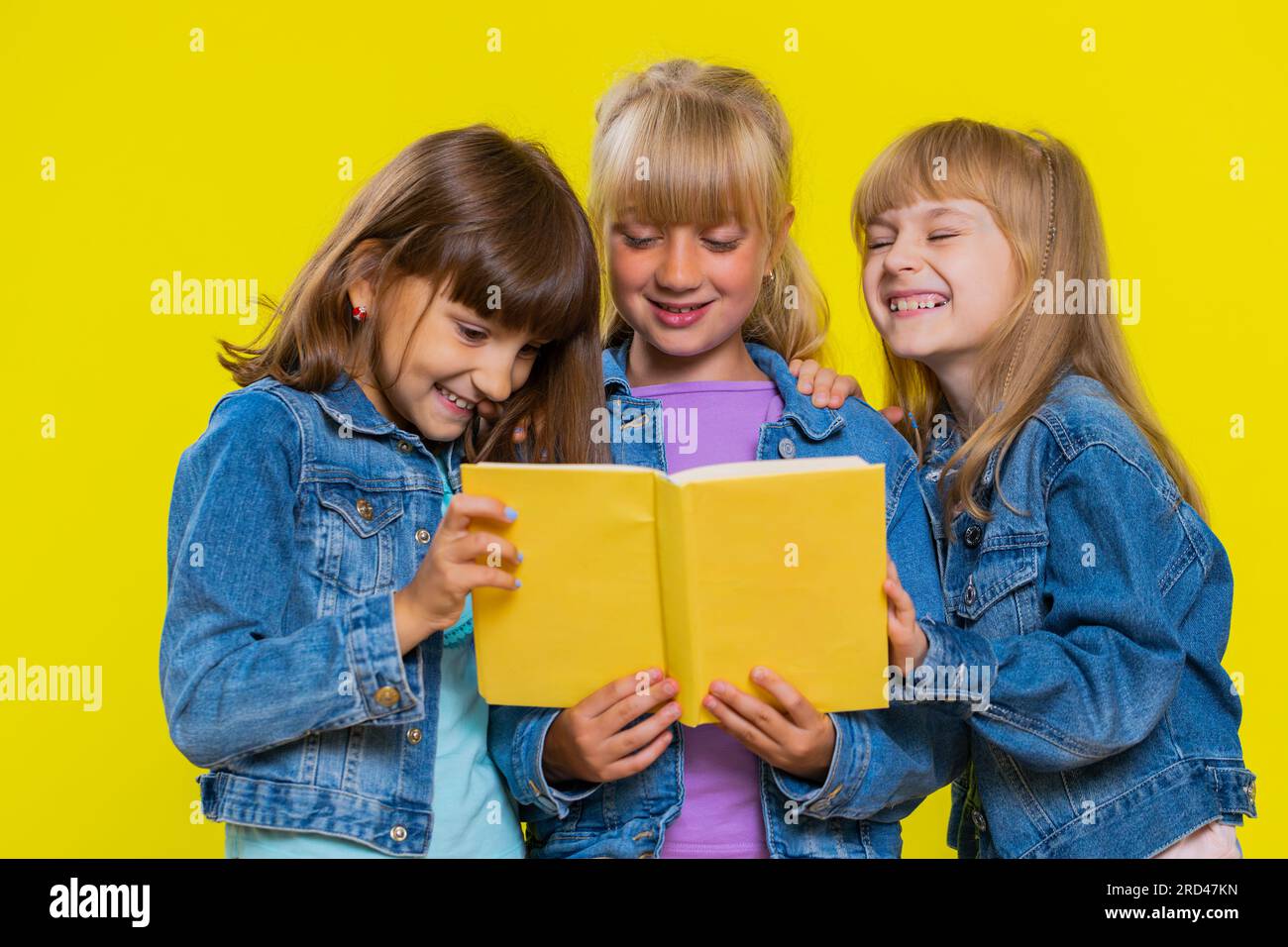 Teenage girls reading funny interesting fairytale story book, leisure hobby, knowledge wisdom ...