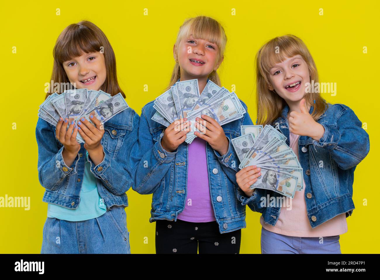 Rich happy teenage girls waving money dollar cash banknotes bills like ...