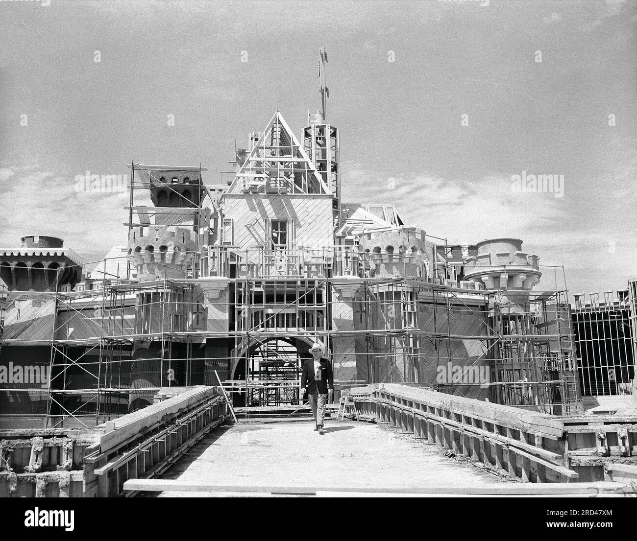 Walt Disney crosses the drawbridge that serves as the entrance to the ...