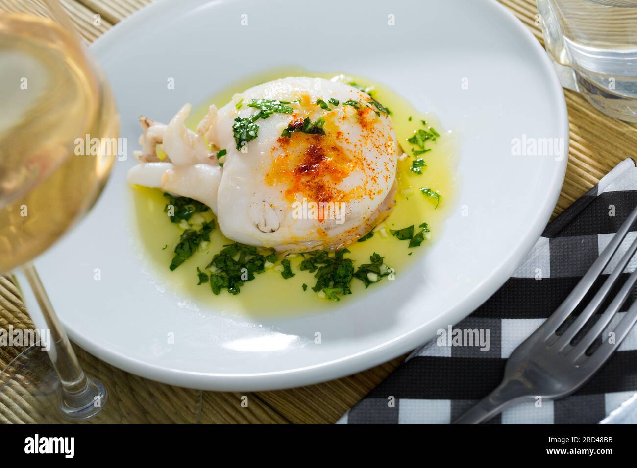 Roasted sepia with green sauce Stock Photo - Alamy