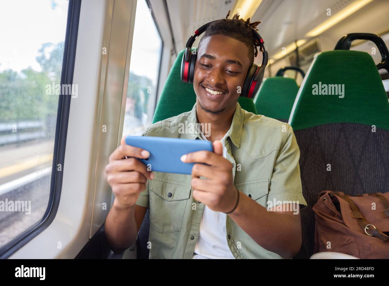 Man on train and phone hi-res stock photography and images - Alamy