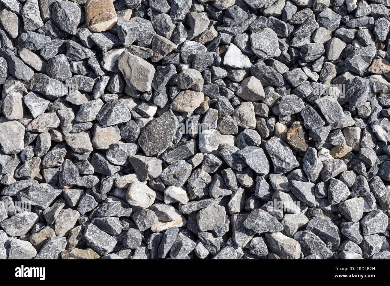 Crushed grey stone on the ground texture background Stock Photo - Alamy