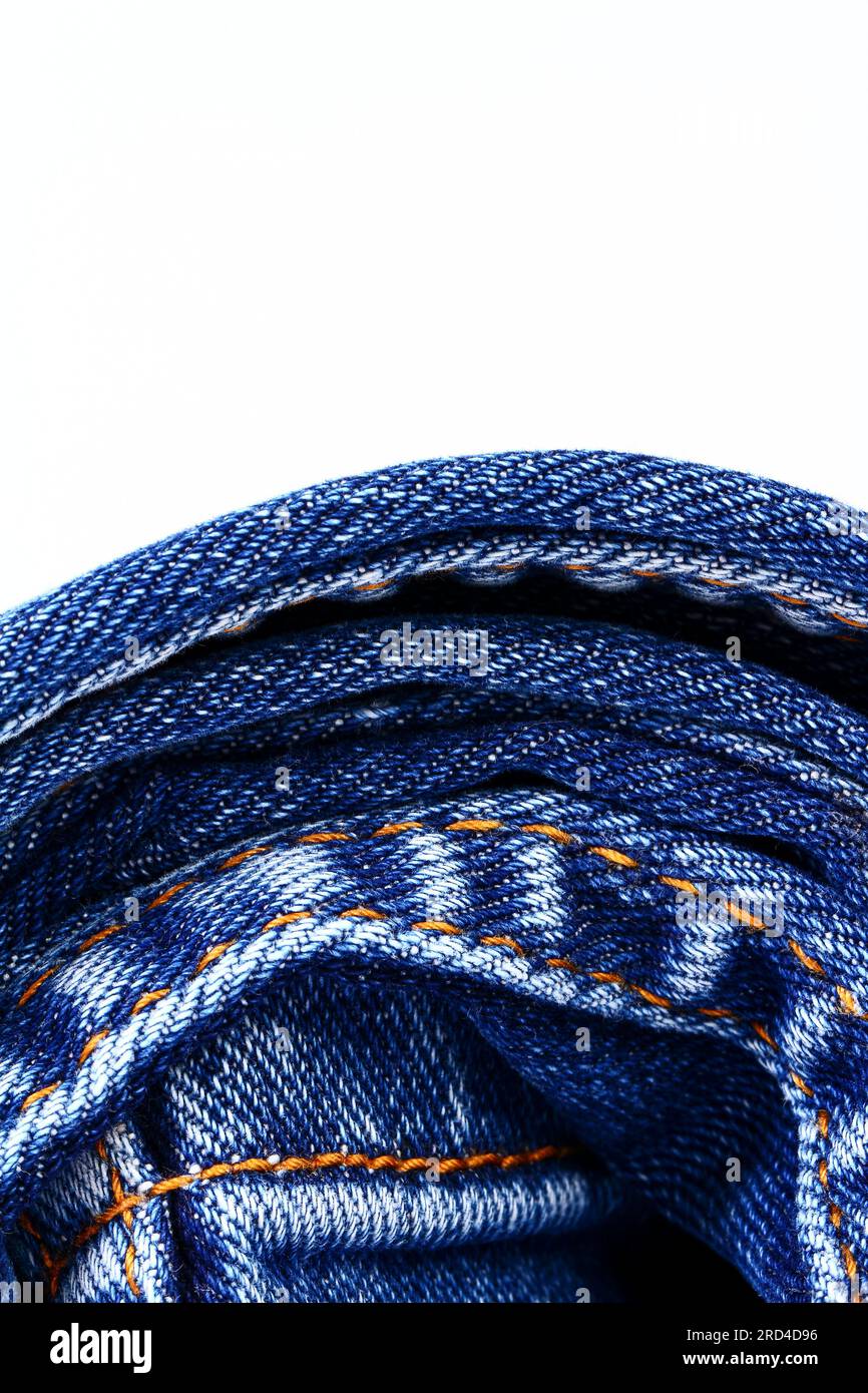 Rolled up blue denim jeans isolated on a white background with copy ...