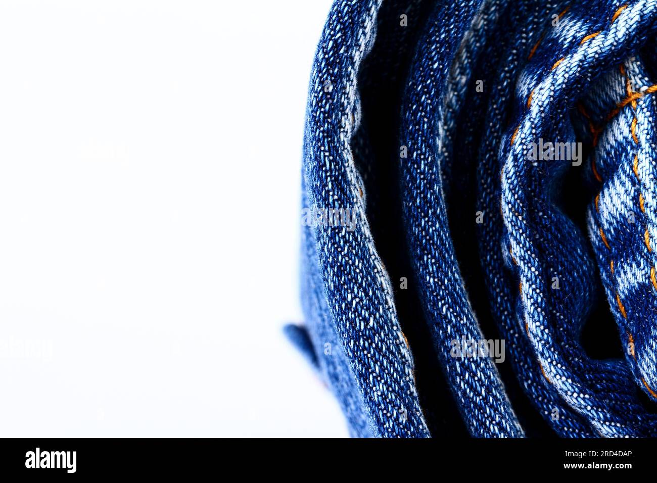 Rolled up blue denim jeans isolated on a white background with copy ...