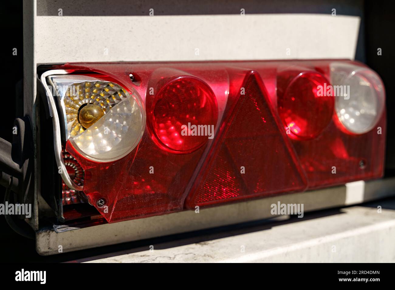 Close-up of the rear light of a truck semi-trailer with a damaged body ...