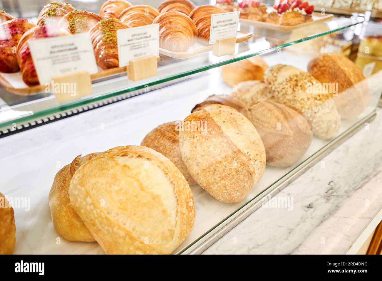 Different kinds of bread on the counter in the bakery shop. Fresh bread ...