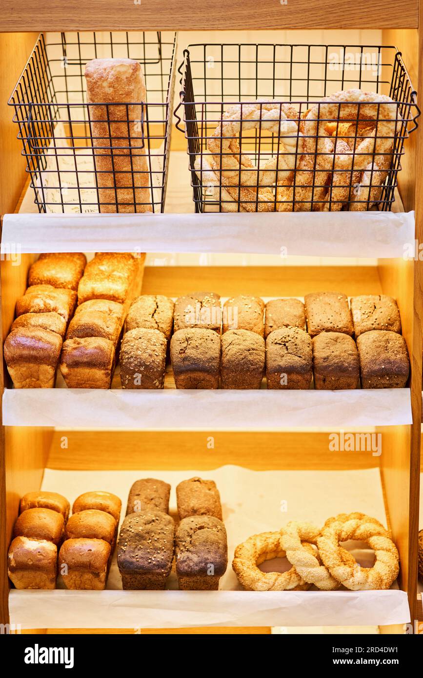 Different kinds of bread on the counter in the bakery shop. Fresh bread ...