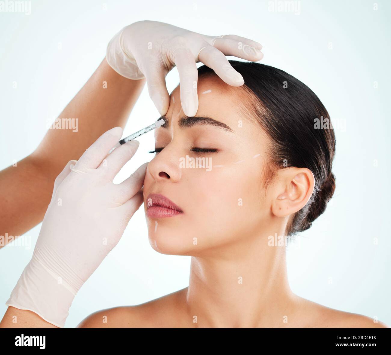 Woman, skincare and face injection for plastic surgery in studio ...