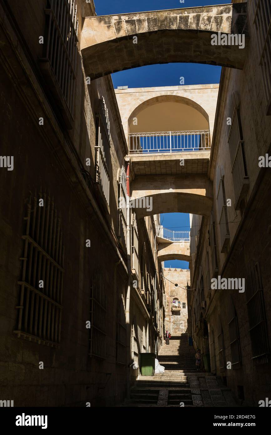 Vertical view of a narrow street under arches in the Muslim Quarter of ...