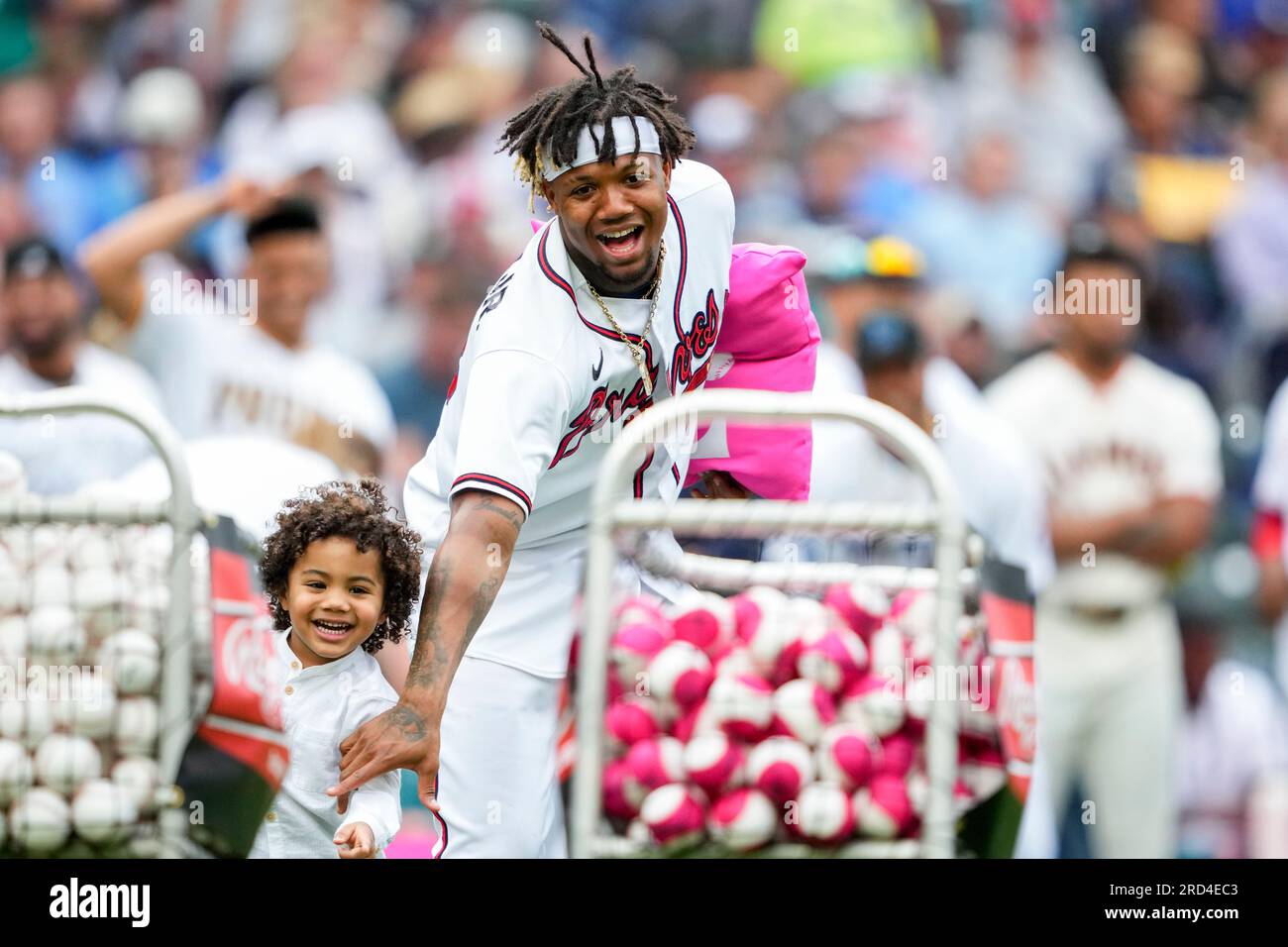 National League's Ronald Acuña Jr., of the Atlanta Braves, grabs his ...