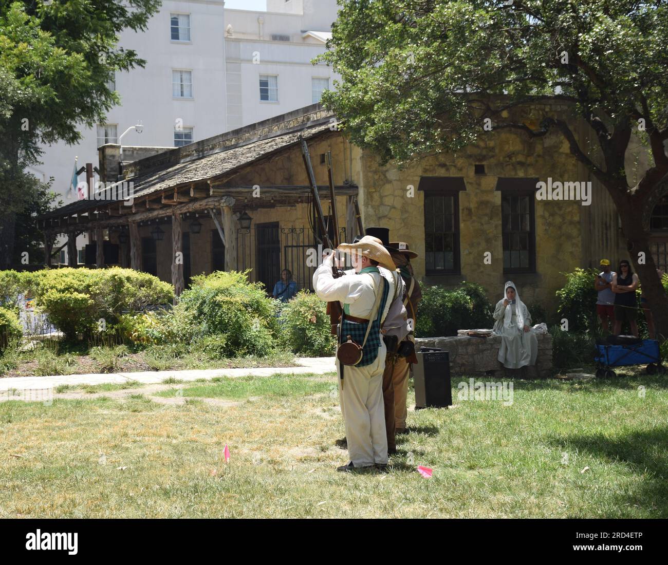 Alamo staff demonstrating the use of flintlock firearms at Alamo Plaza ...