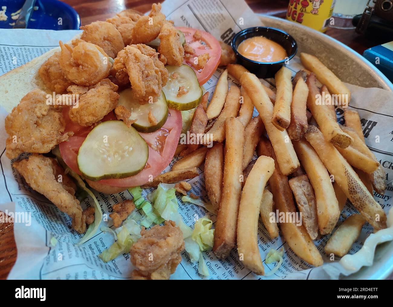 Fried shrimp pop corns served with french fries at a restaurant Stock ...