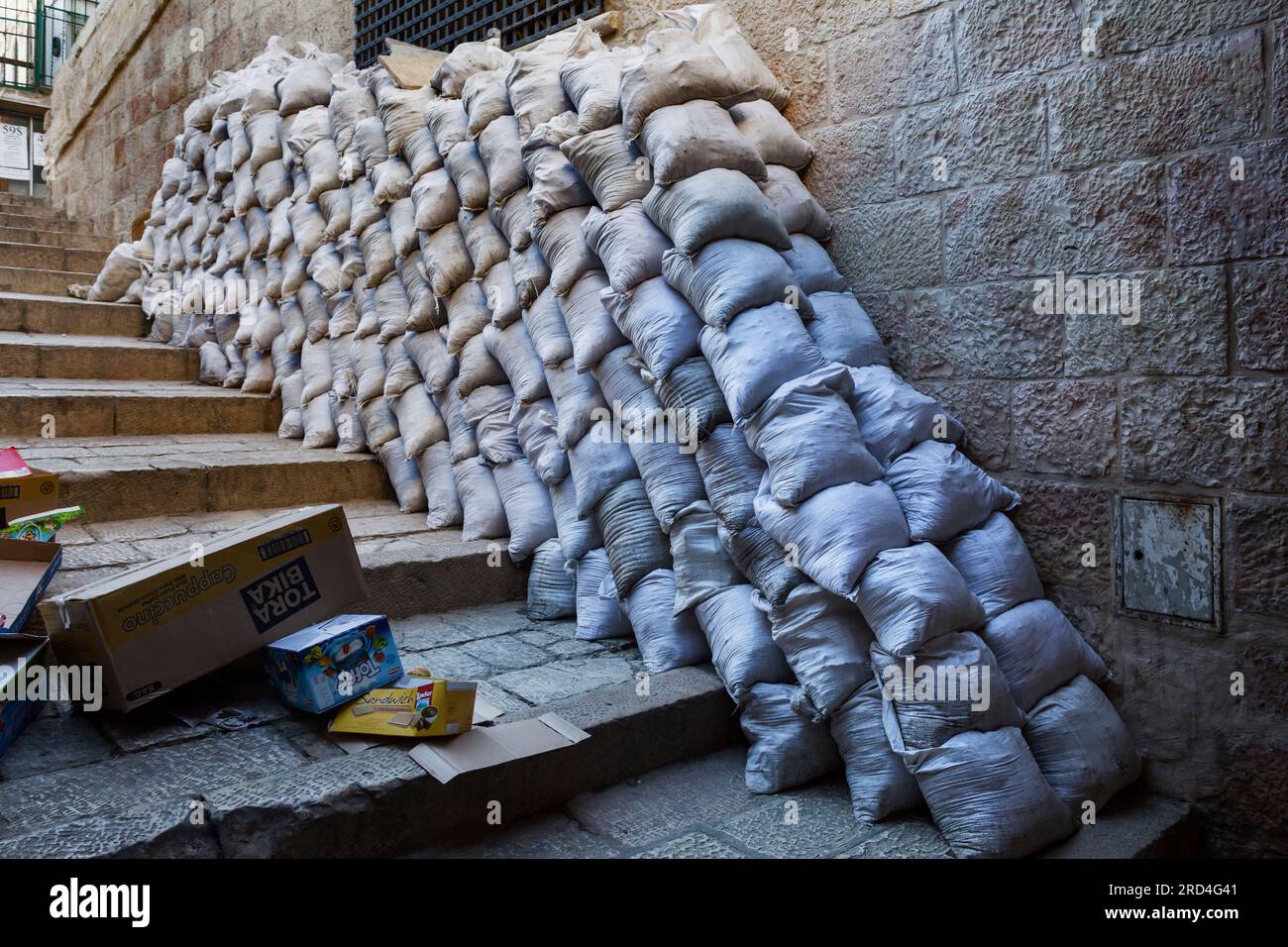 Horizontal view of a huge pile of sacks on the stairs of a Muslim ...