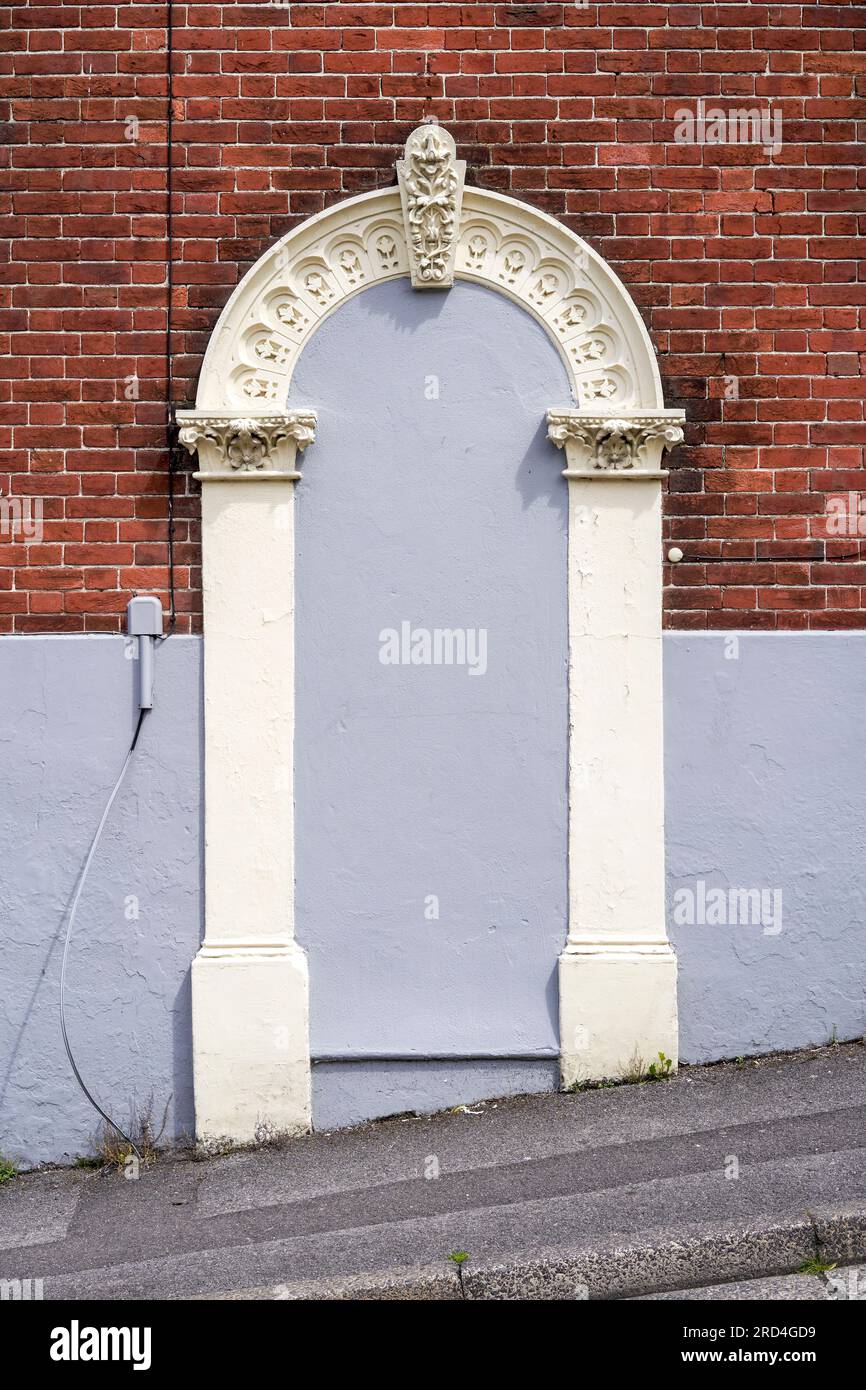 Blocked up doorway with ornate arch and pillars on a steep hill Stock ...