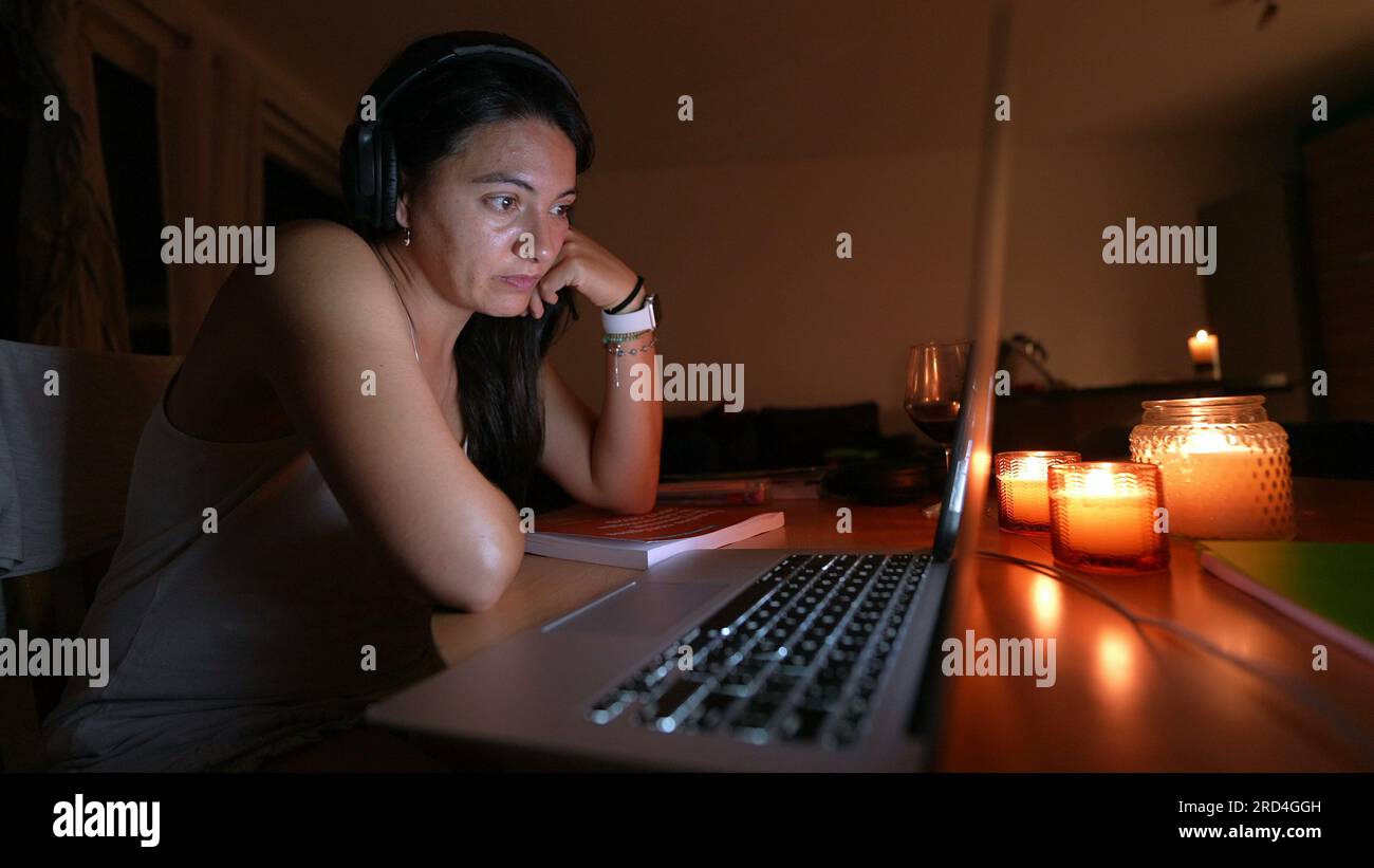 Person talking in front of computer screen at night woman in video ...
