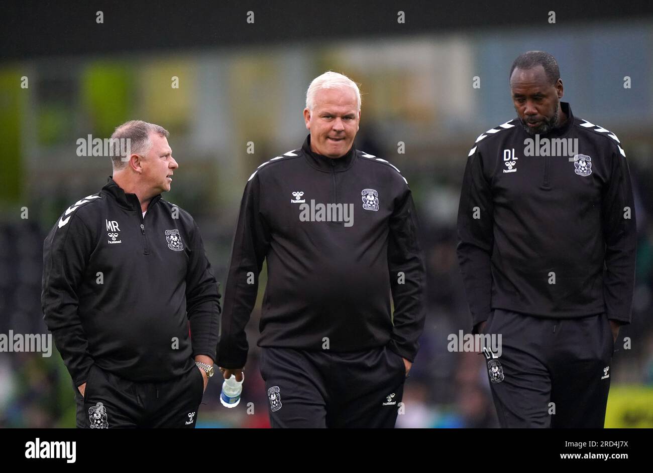 Coventry City manager Mark Robins (left) with assistants Adi Viveash ...