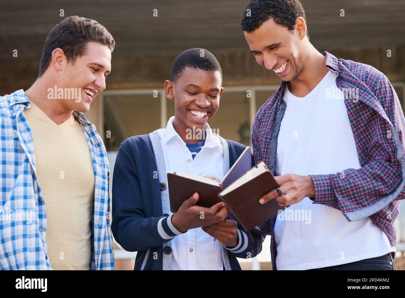 Comparing notes. Cropped shot of a group of university students looking ...
