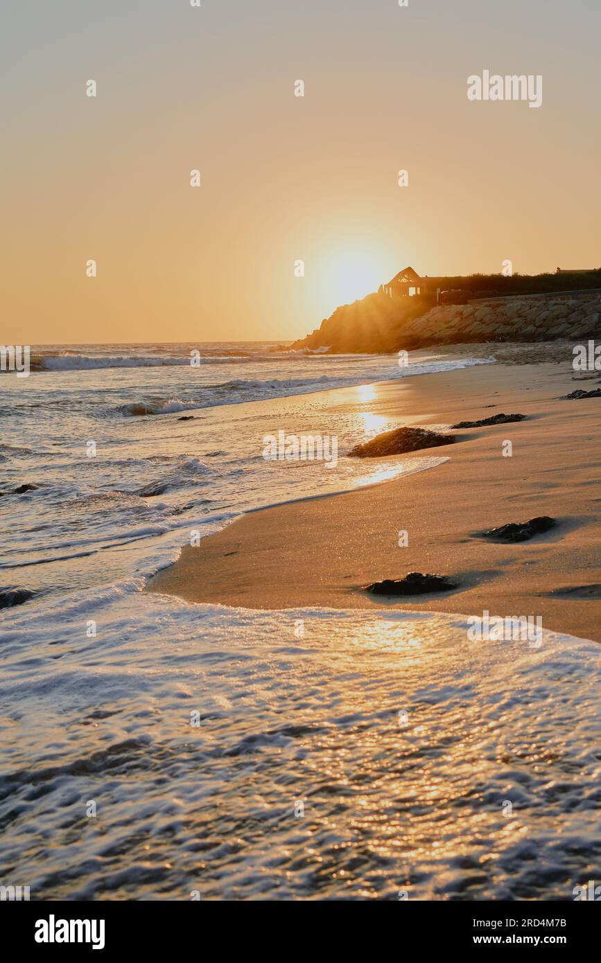 sunset on the beach with nice colors and reflection Stock Photo - Alamy