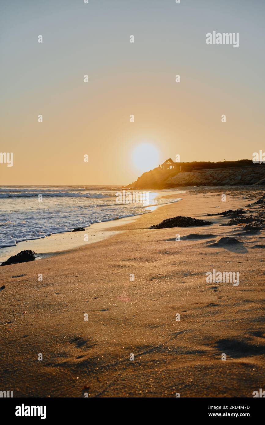 sunset on the beach with nice colors and reflection Stock Photo - Alamy