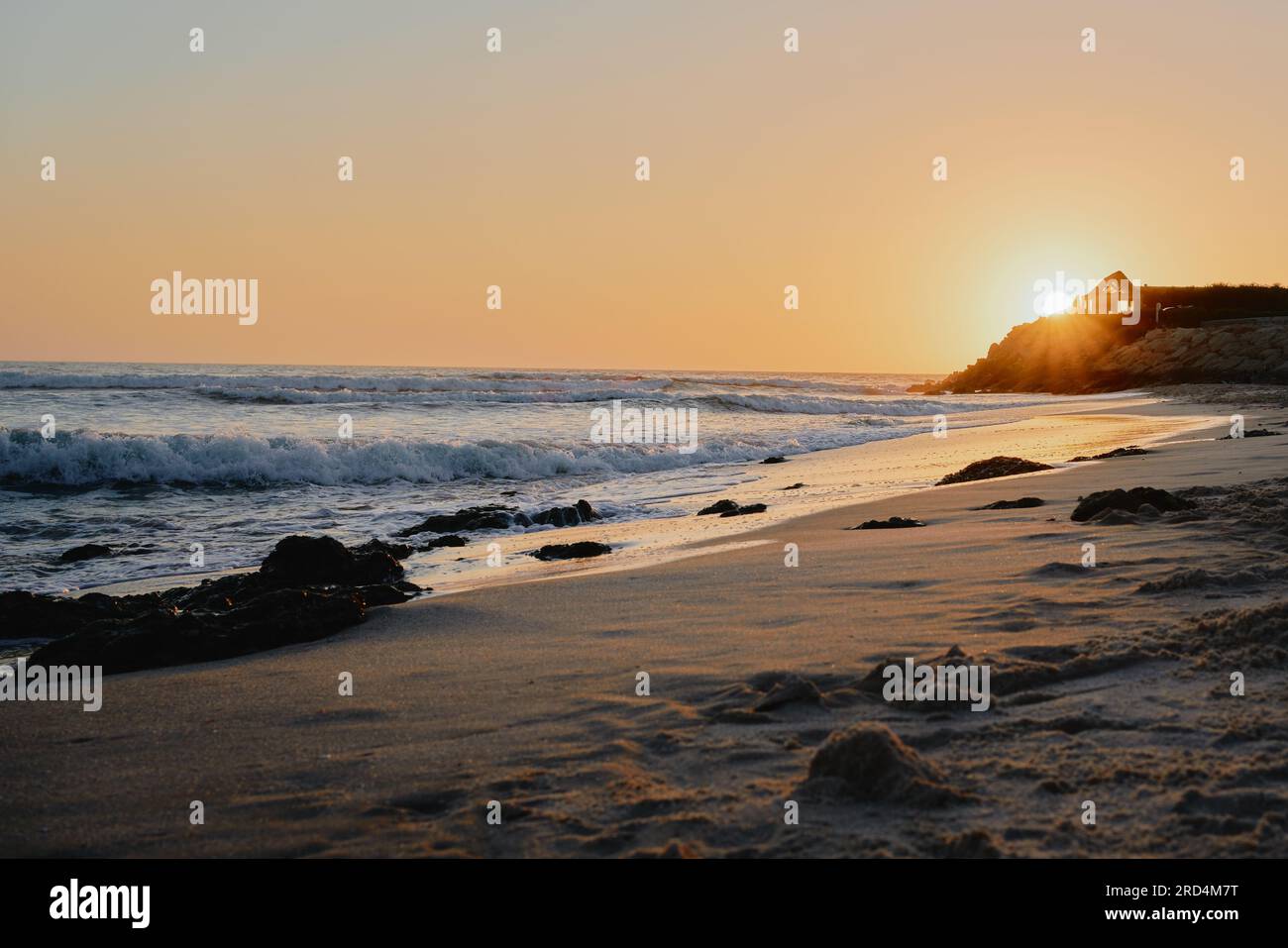 sunset on the beach with nice colors and reflection Stock Photo - Alamy