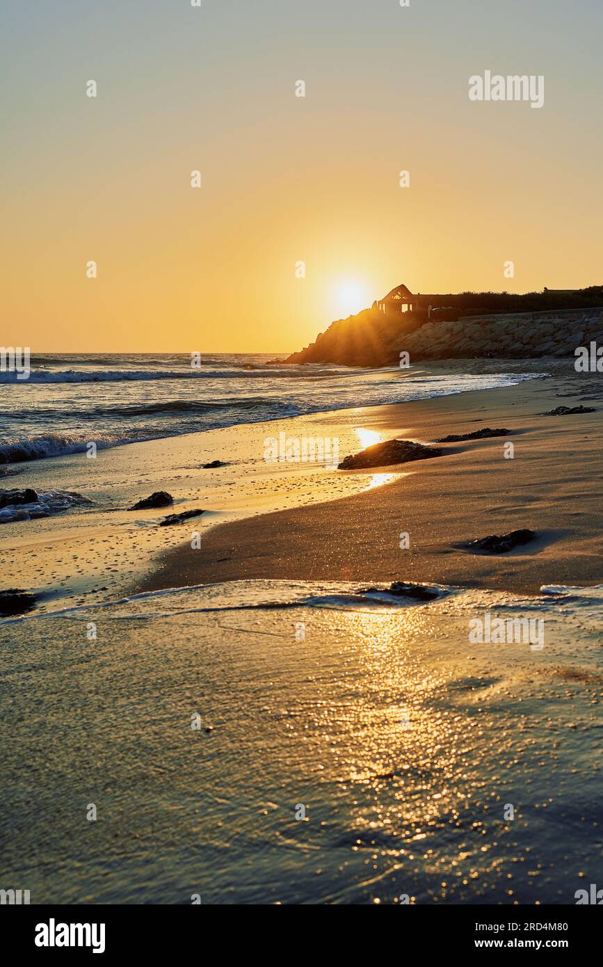 sunset on the beach with nice colors and reflection Stock Photo - Alamy