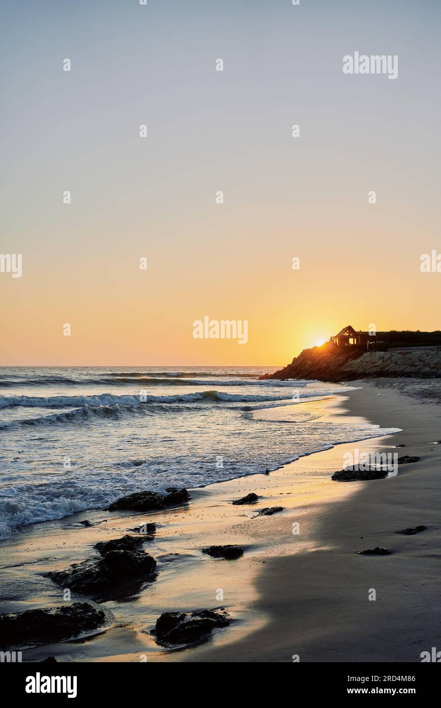 sunset on the beach with nice colors and reflection Stock Photo - Alamy