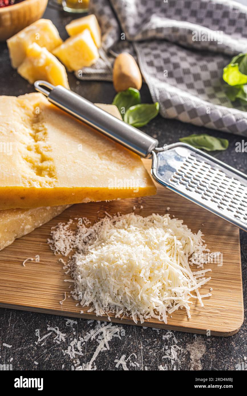 Grated parmesan cheese on the cutting board Stock Photo - Alamy