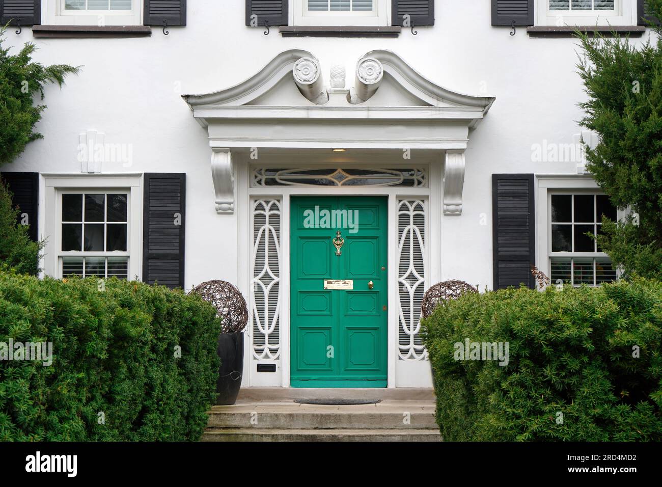 Front door of white stucco house with shrubbery Stock Photo - Alamy