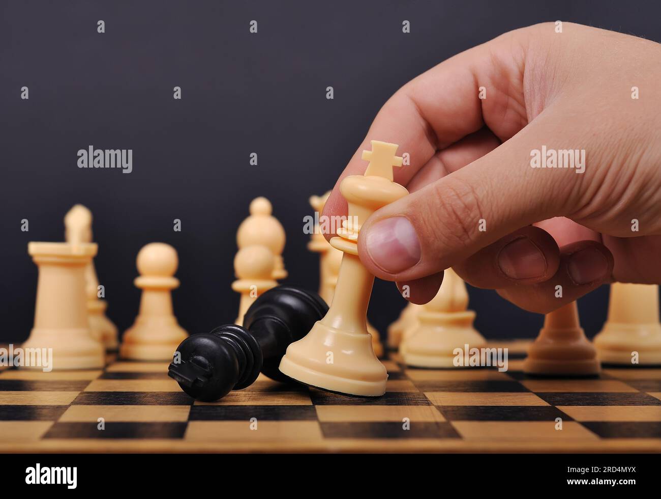 White Chess King makes a checkmate Black King on chessboard Stock Photo ...